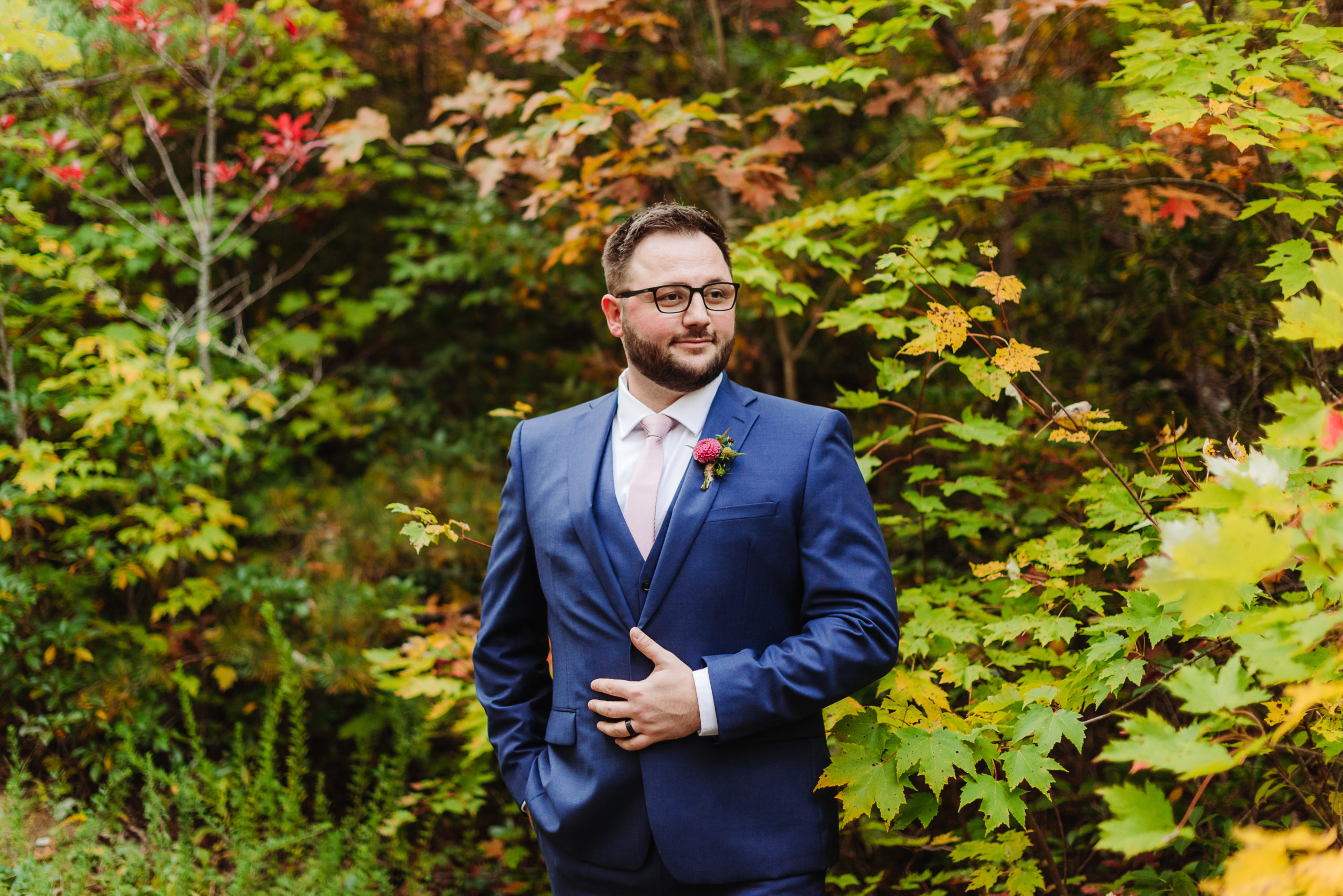 Groom poses in fall leaves ~ Elope Outdoors
